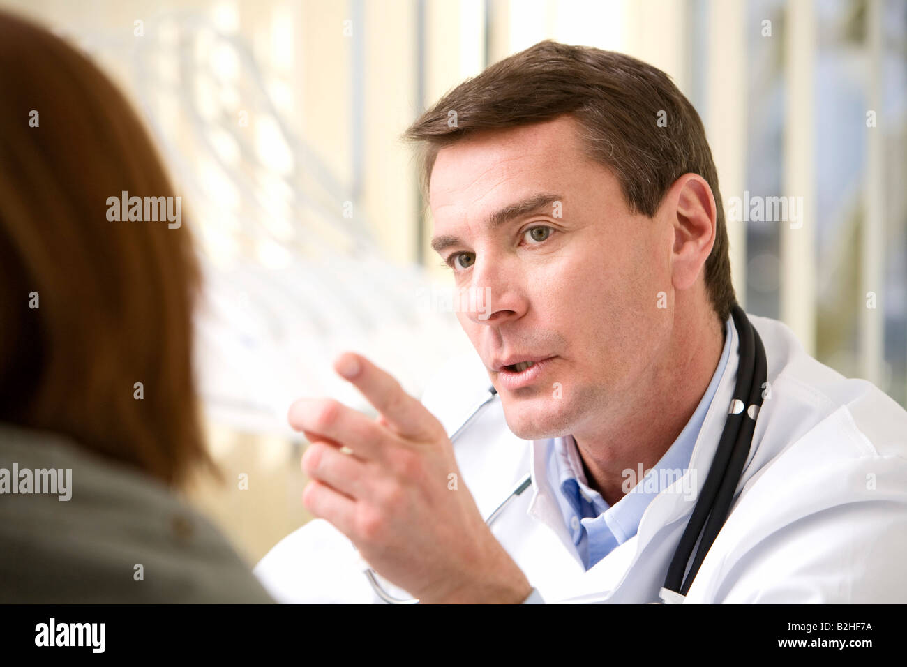 portrait of doctor talking to patient Stock Photo - Alamy