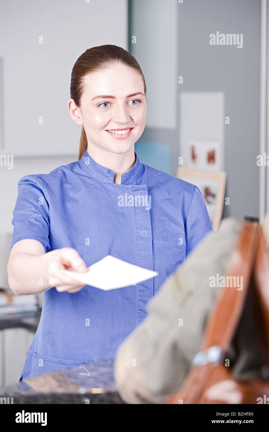 medical assistent giving prescription to patient Stock Photo - Alamy
