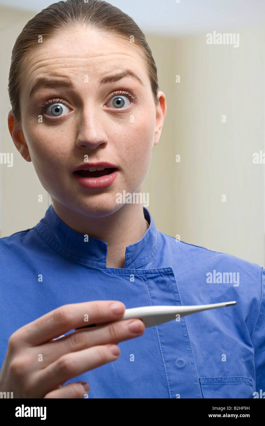 portrait of nurse holding thermometer Stock Photo - Alamy