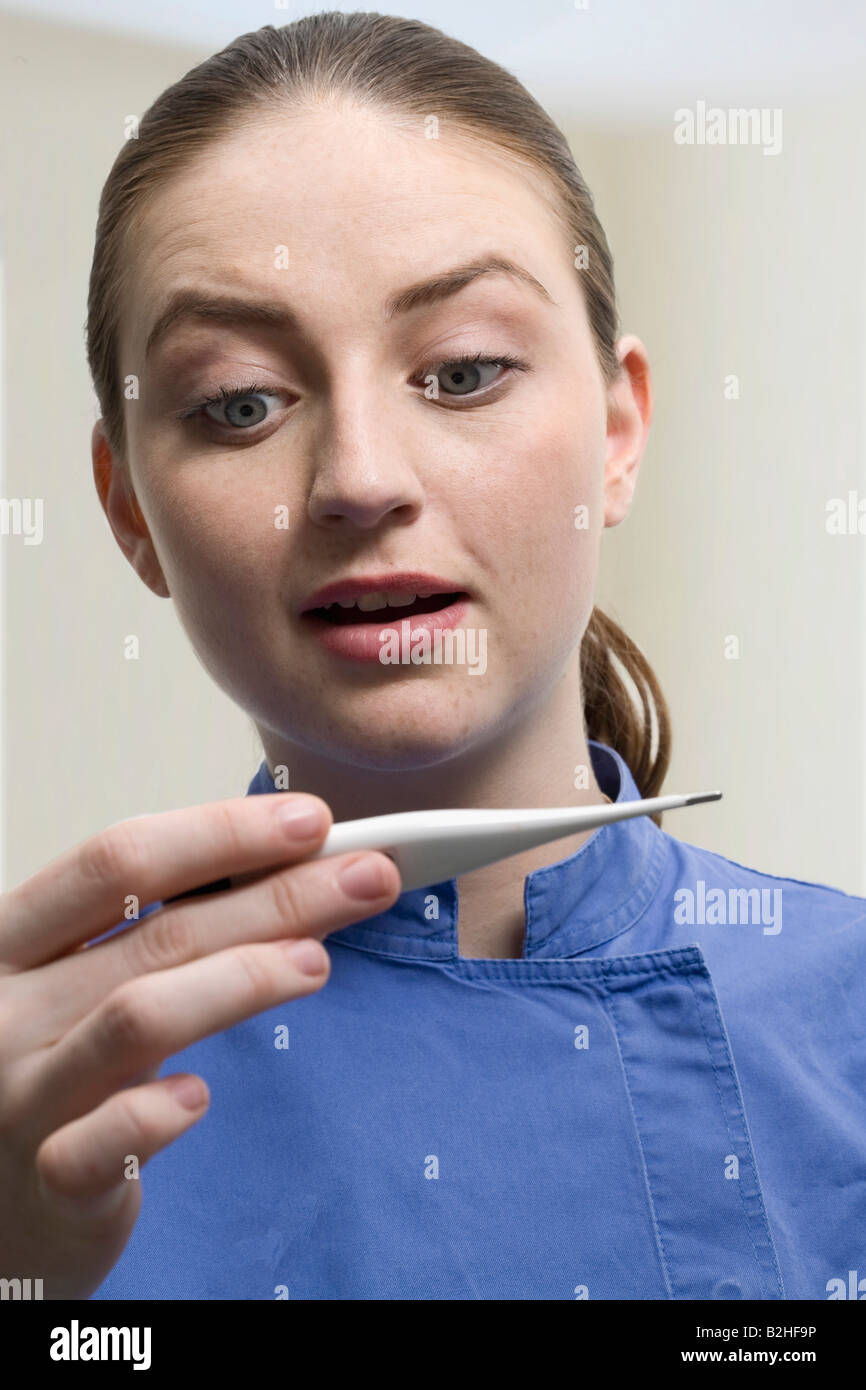 portrait of nurse holding thermometer Stock Photo - Alamy