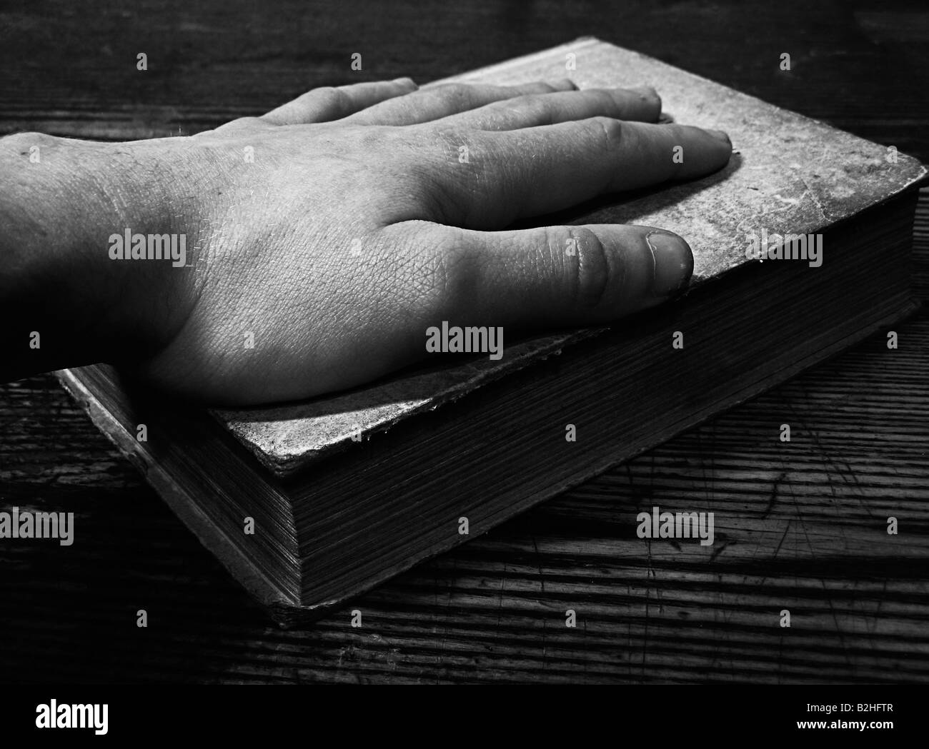 Hand on the old book Stock Photo - Alamy