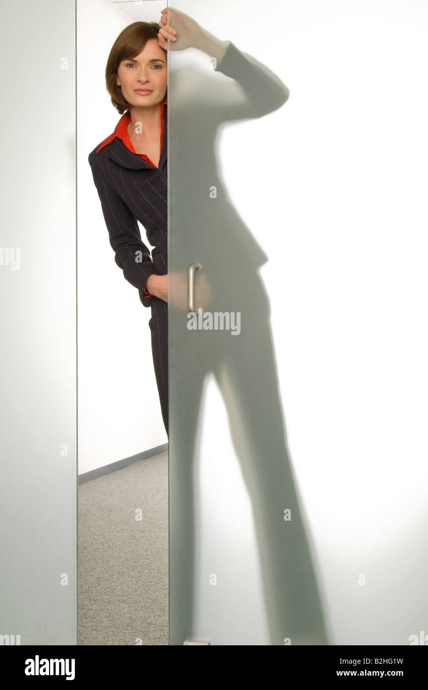Female peeking behind door hi-res stock photography and images - Alamy