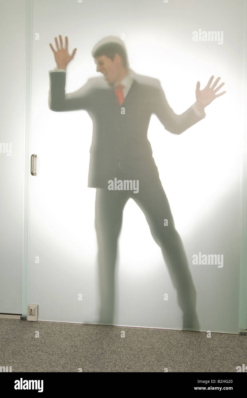 shape of businessman behind glass door Stock Photo - Alamy