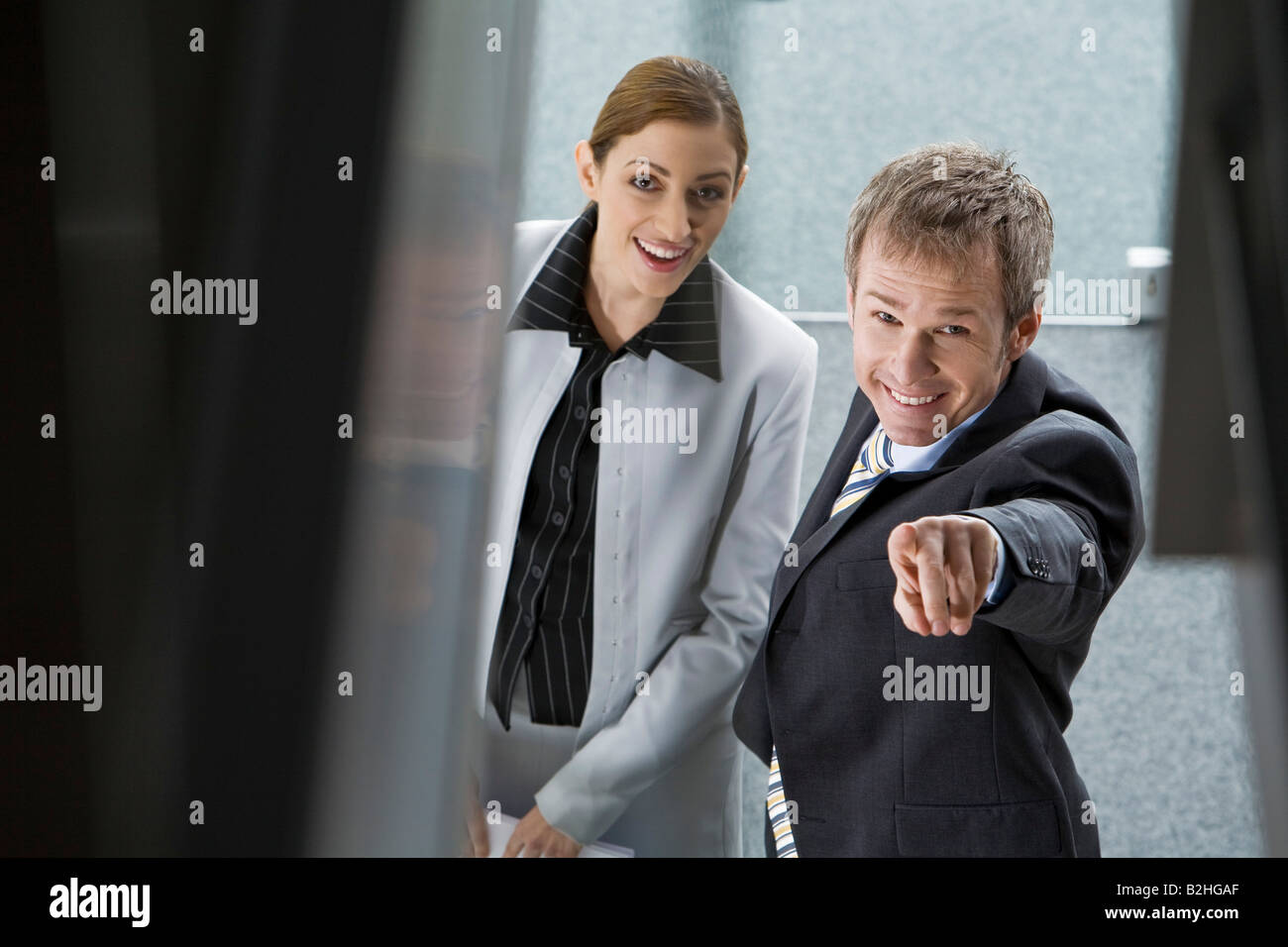portrait of two executives man pointing towards camera Stock Photo - Alamy