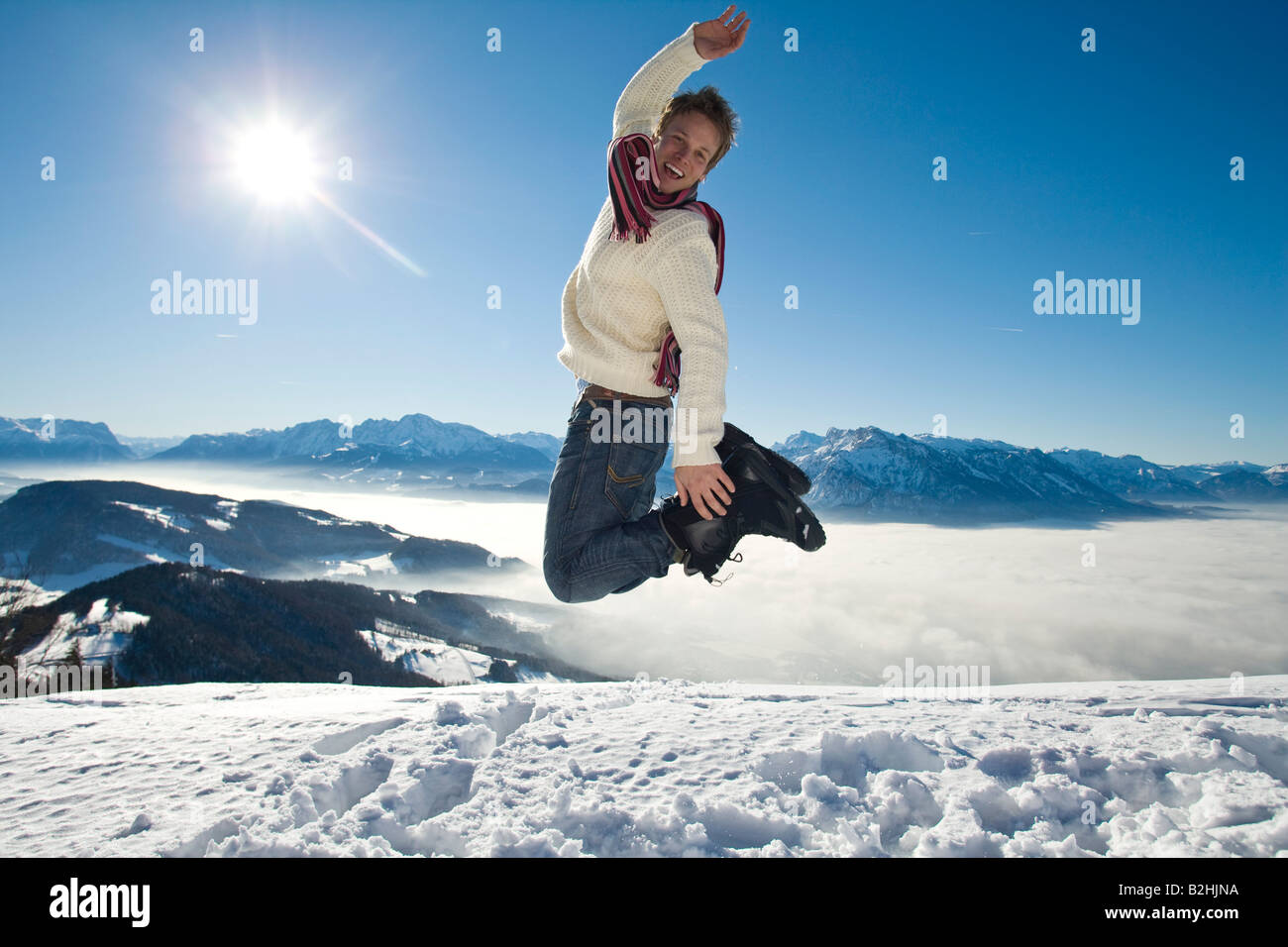 full body portrait of man doing jump on mountain top Stock Photo - Alamy