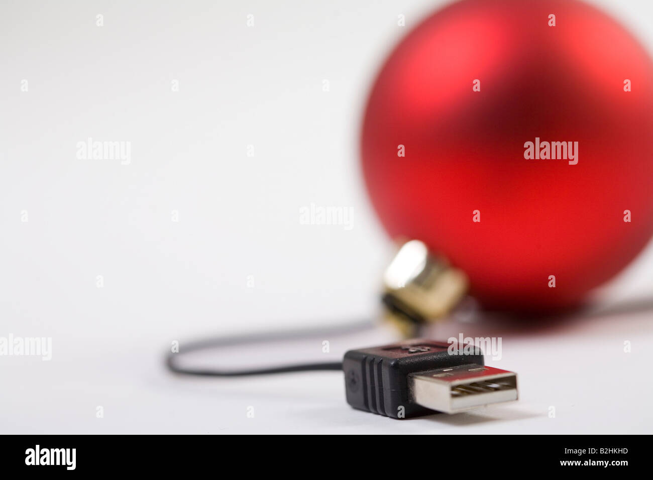 still life of bauble connected to computer cable Stock Photo - Alamy