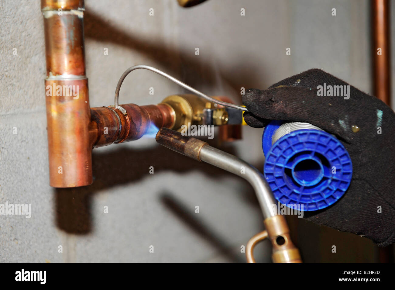 Plumber installing copper water piping for new residential home Stock ...