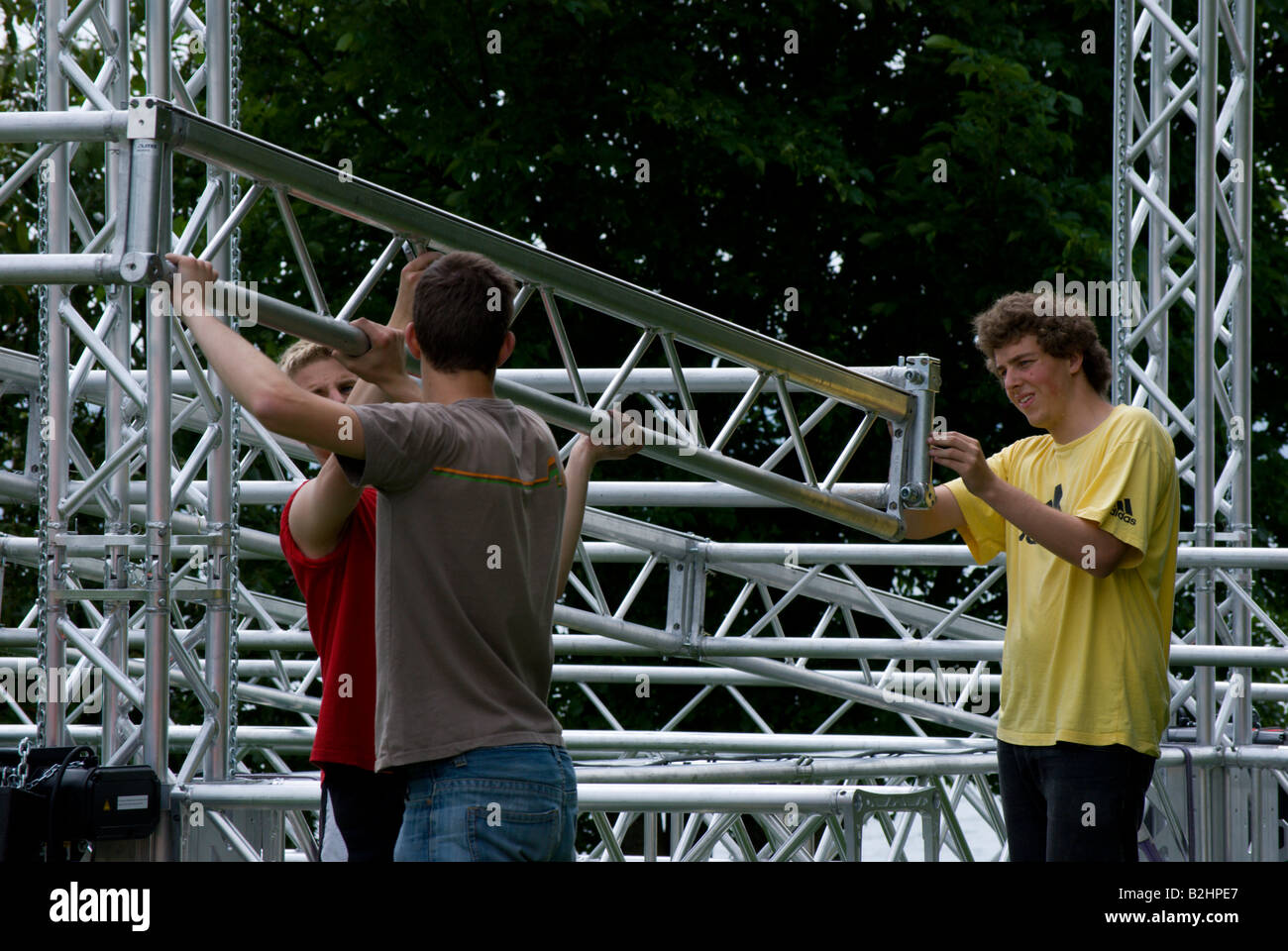 Workers erecting a temporary stage for an open air concert at Festi ...
