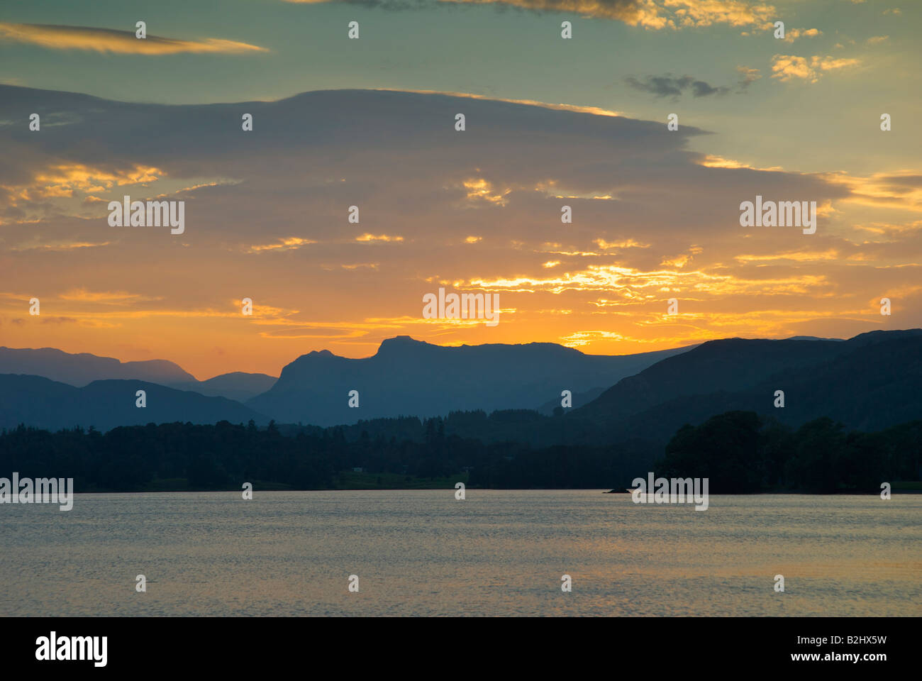 The Langdale Pikes, silhouetted at sunset, over Lake Windermere, Lake ...