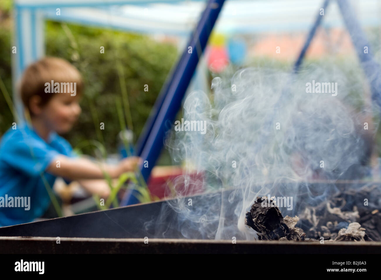 Smoking barbecue and child Stock Photo - Alamy