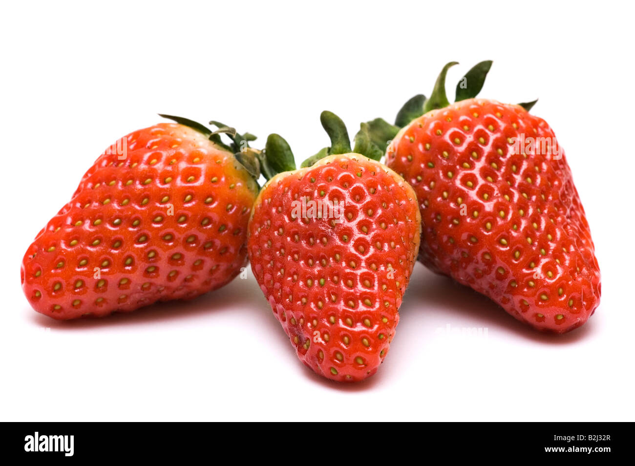 Three isolated strawberries Stock Photo - Alamy