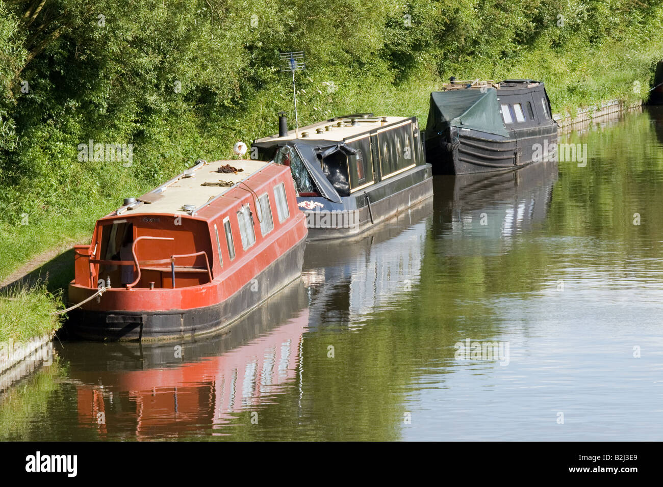 Three barges moored at a cannel side Stock Photo - Alamy