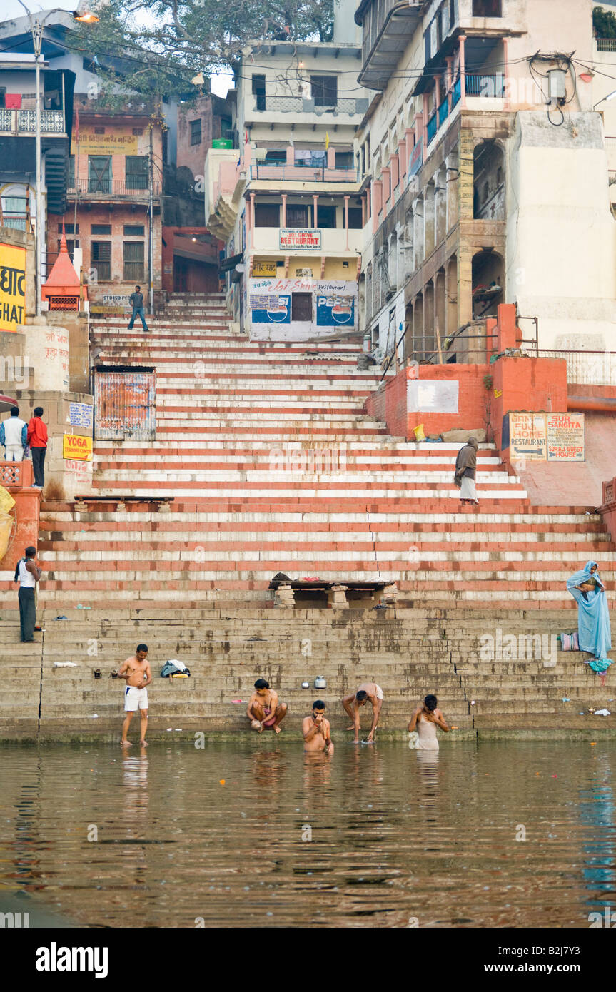 Hindu men performing the ritual of daily ablutions in the River Ganges ...