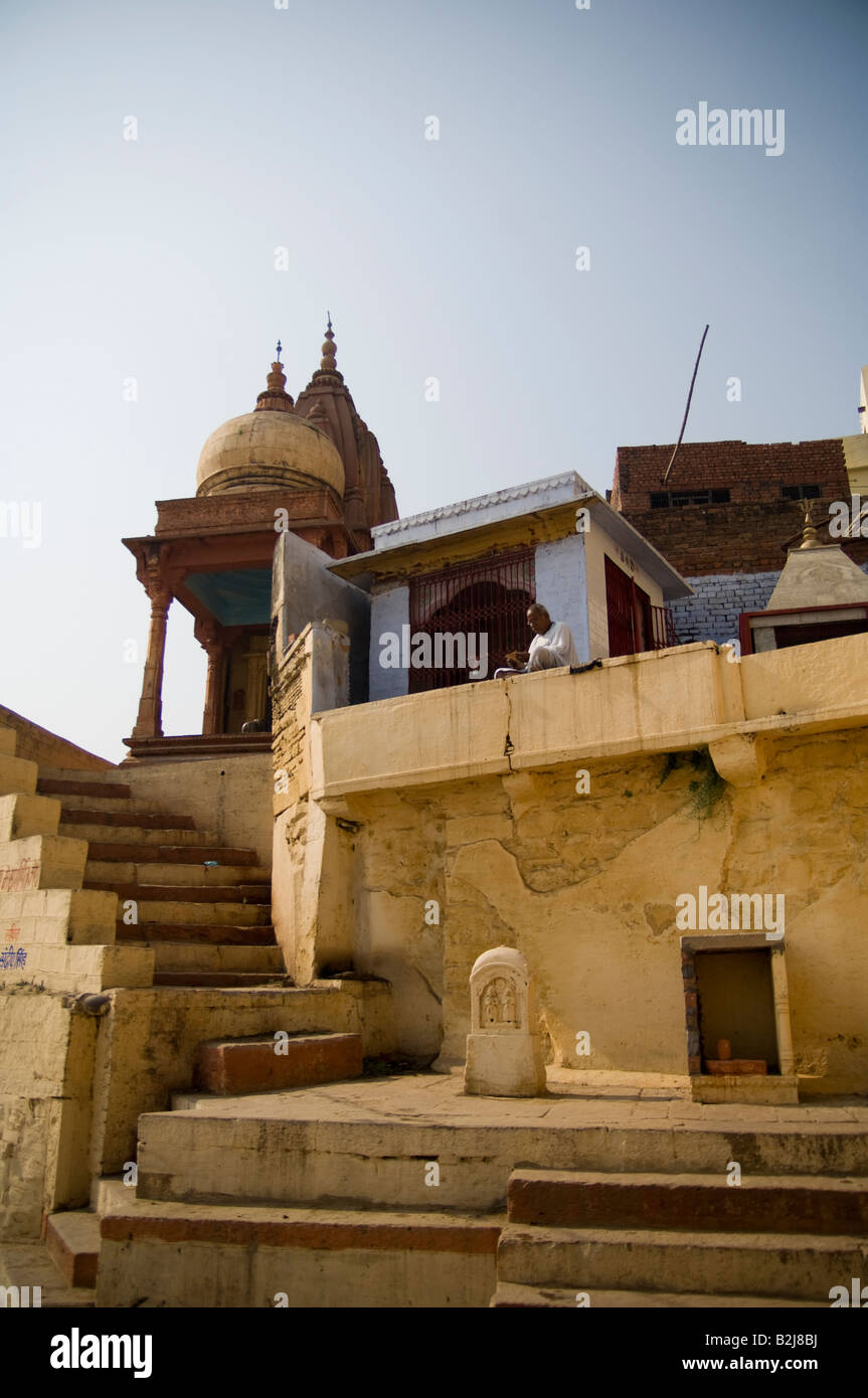 Hindu man reading scriptures outside a temple in Varanasi, India Stock ...