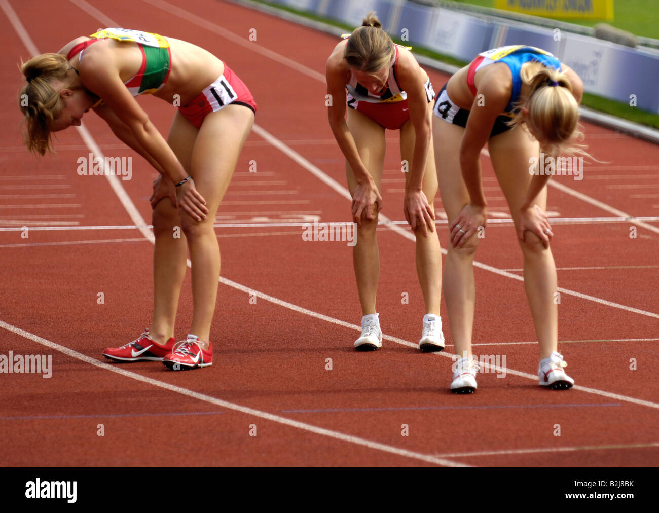 Three Females Athletes In Oxygen Debt After Race Stock Photo Alamy