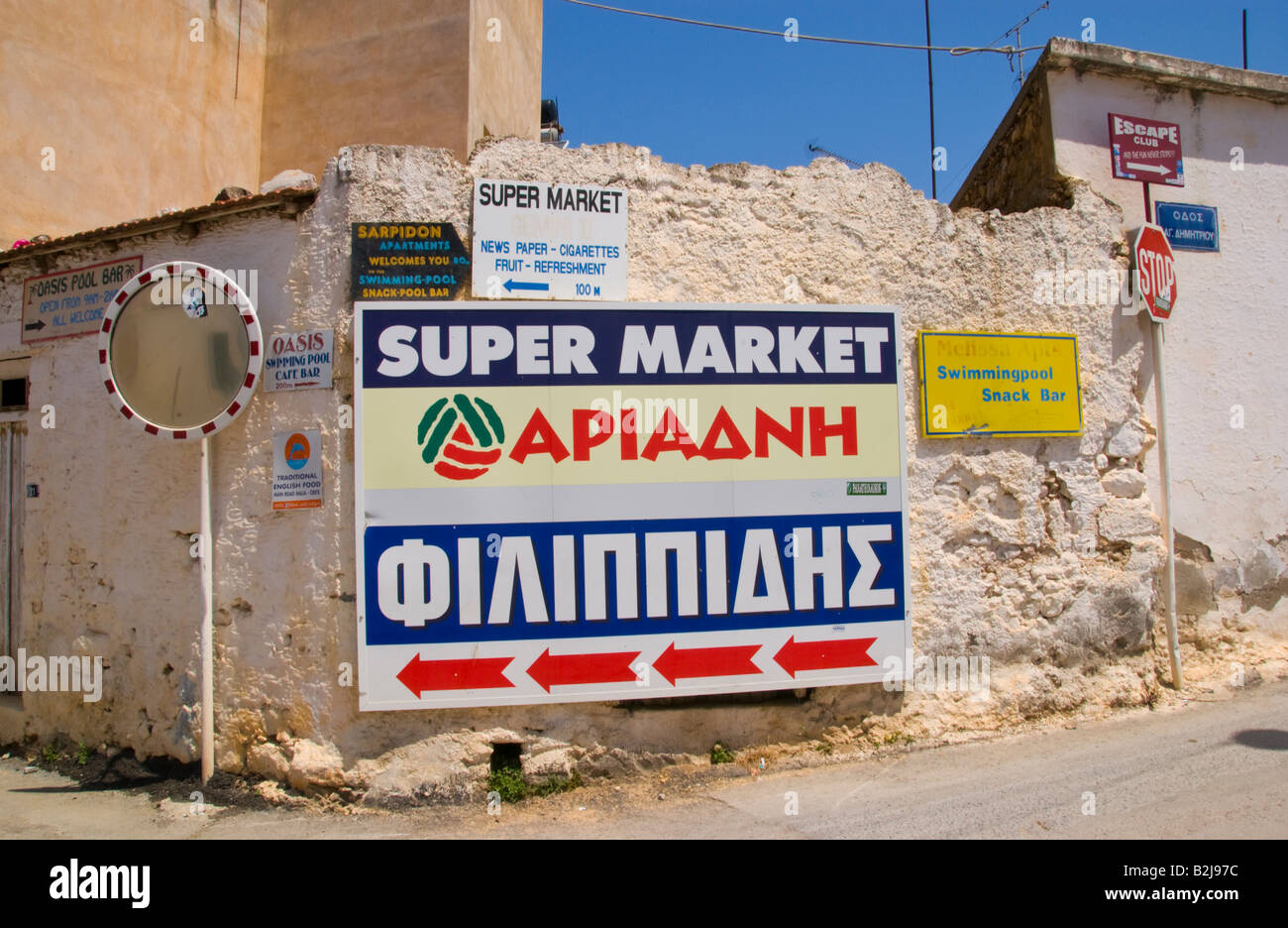 Signs for tourists in Malia Old Town on the Greek Mediterranean island ...