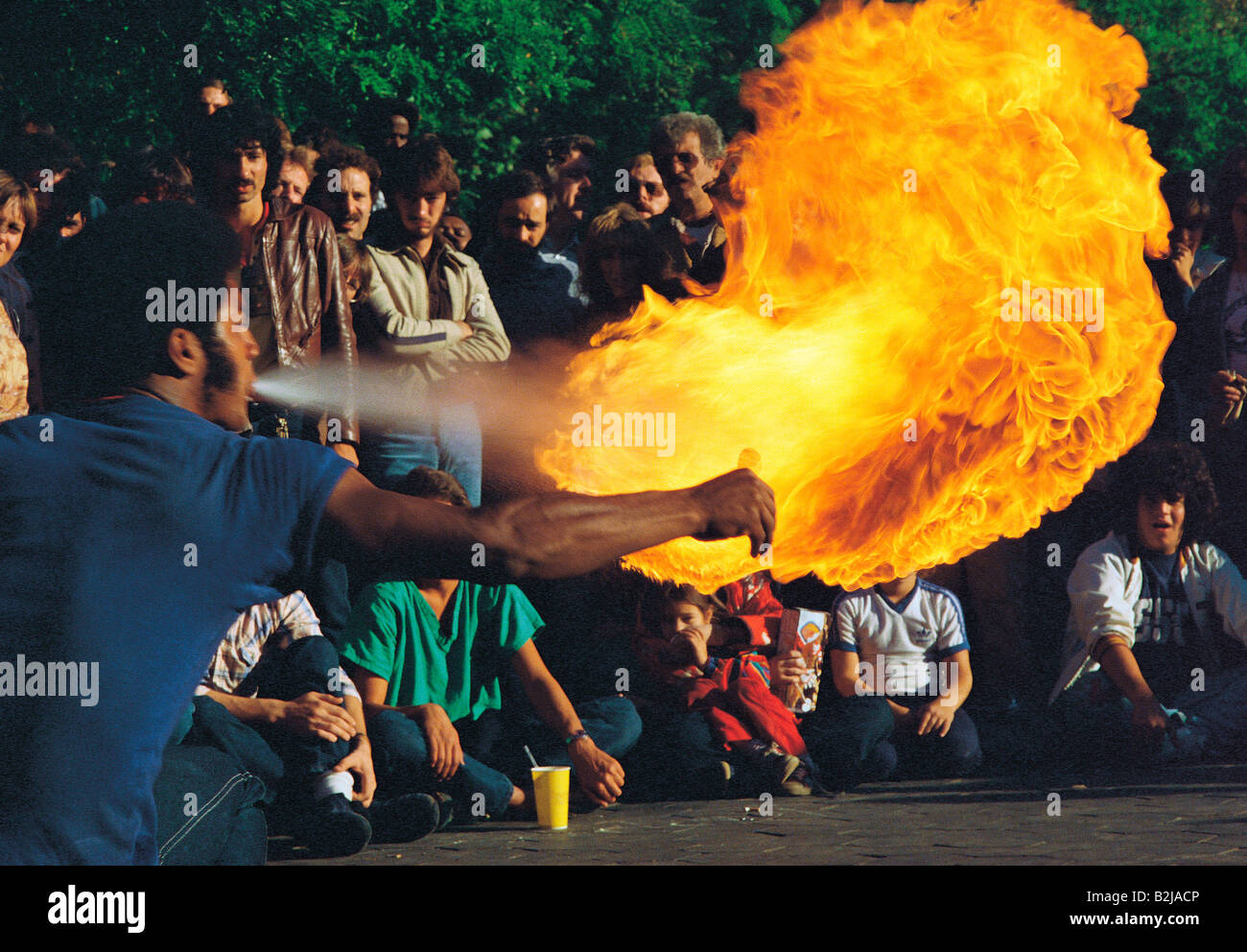 Side view of a fire-eater performing in the street. New York city. USA ...