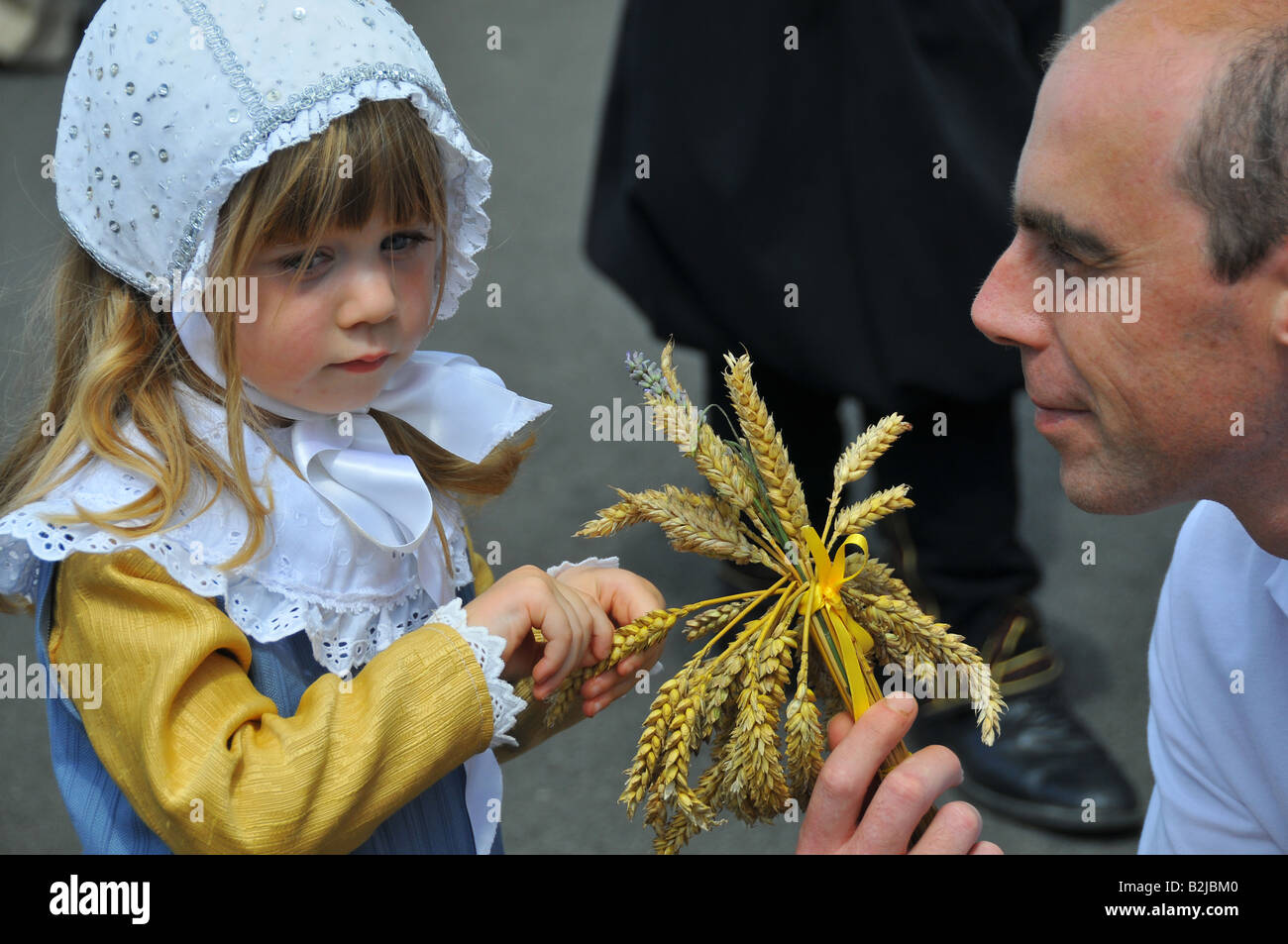 french kid with her father dressed in traditional costume with headgear ...