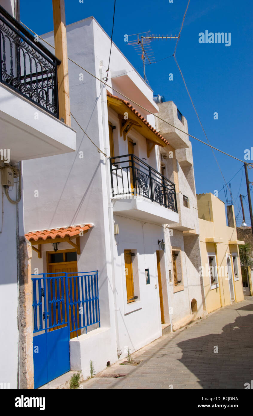Traditional housing on narrow street in Malia Old Town on the Greek ...