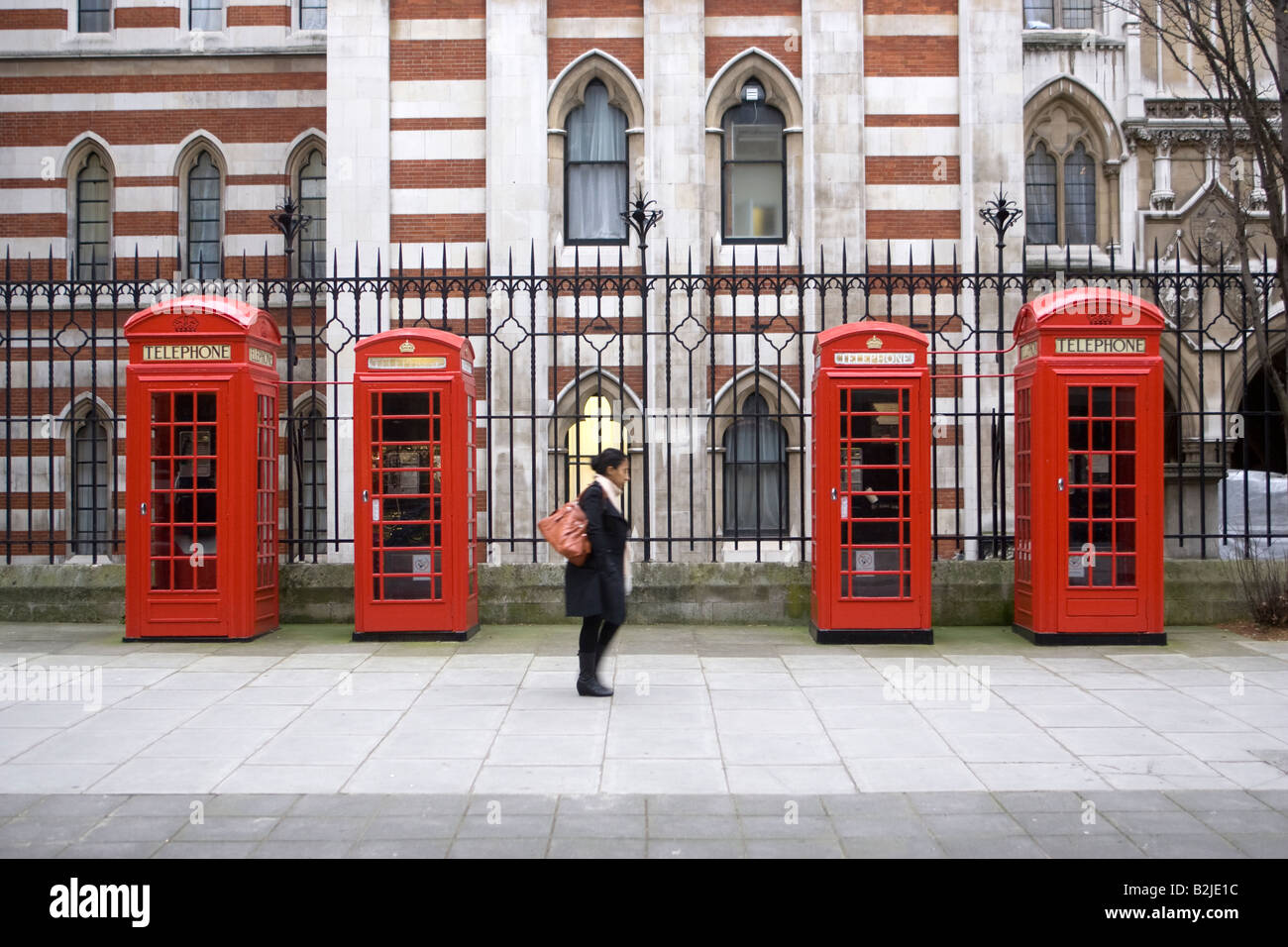 Four red telephone boxes in a row in Carey Street London England UK ...