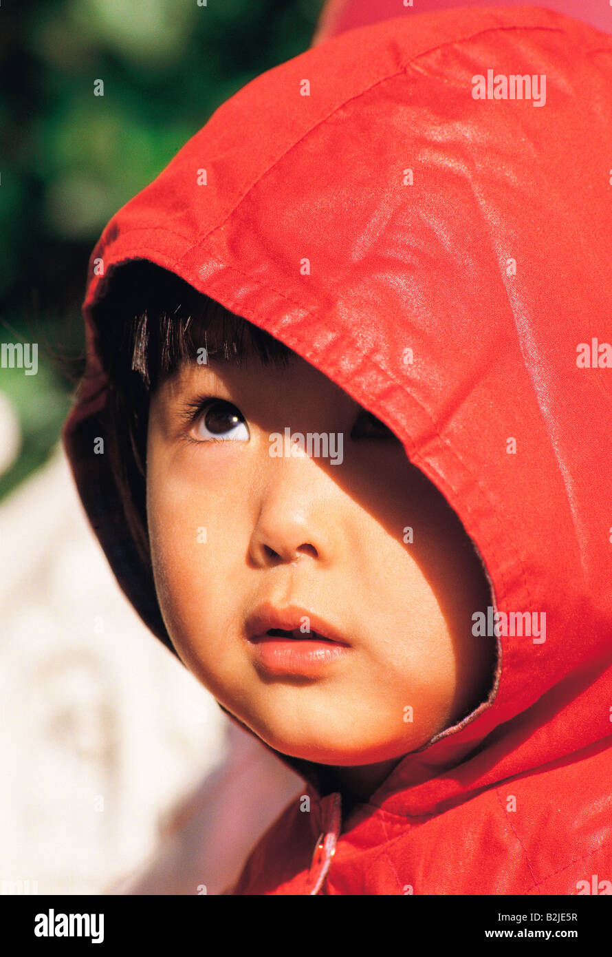 Outdoors close up view of a girl child wearing a hood over her head ...
