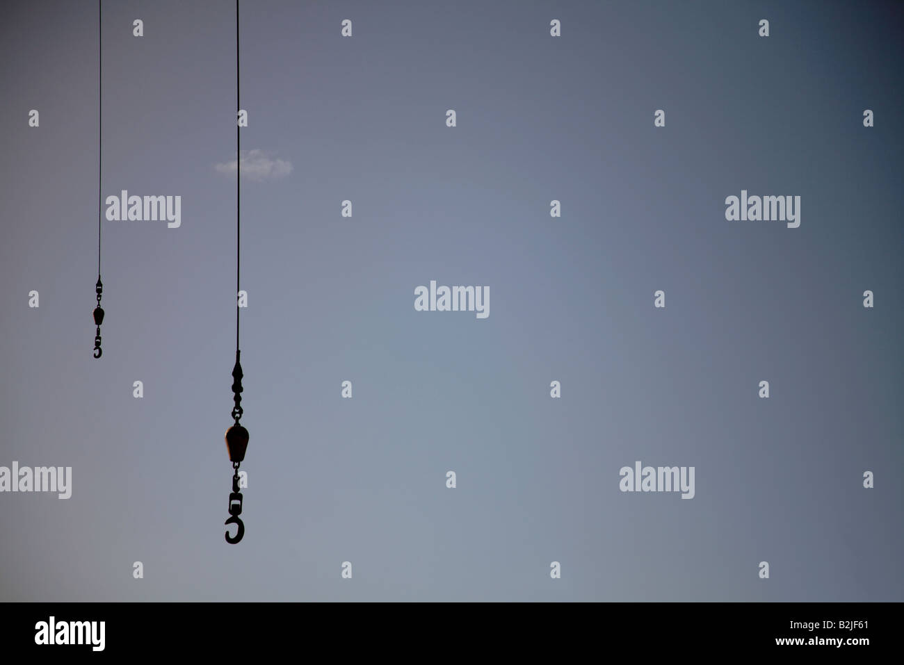 Derrick hooks hanging from the sky Stock Photo - Alamy