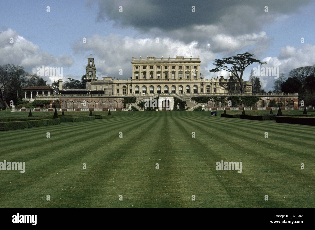 Cliveden House with manicured lawn and geometric topiary gardens ...