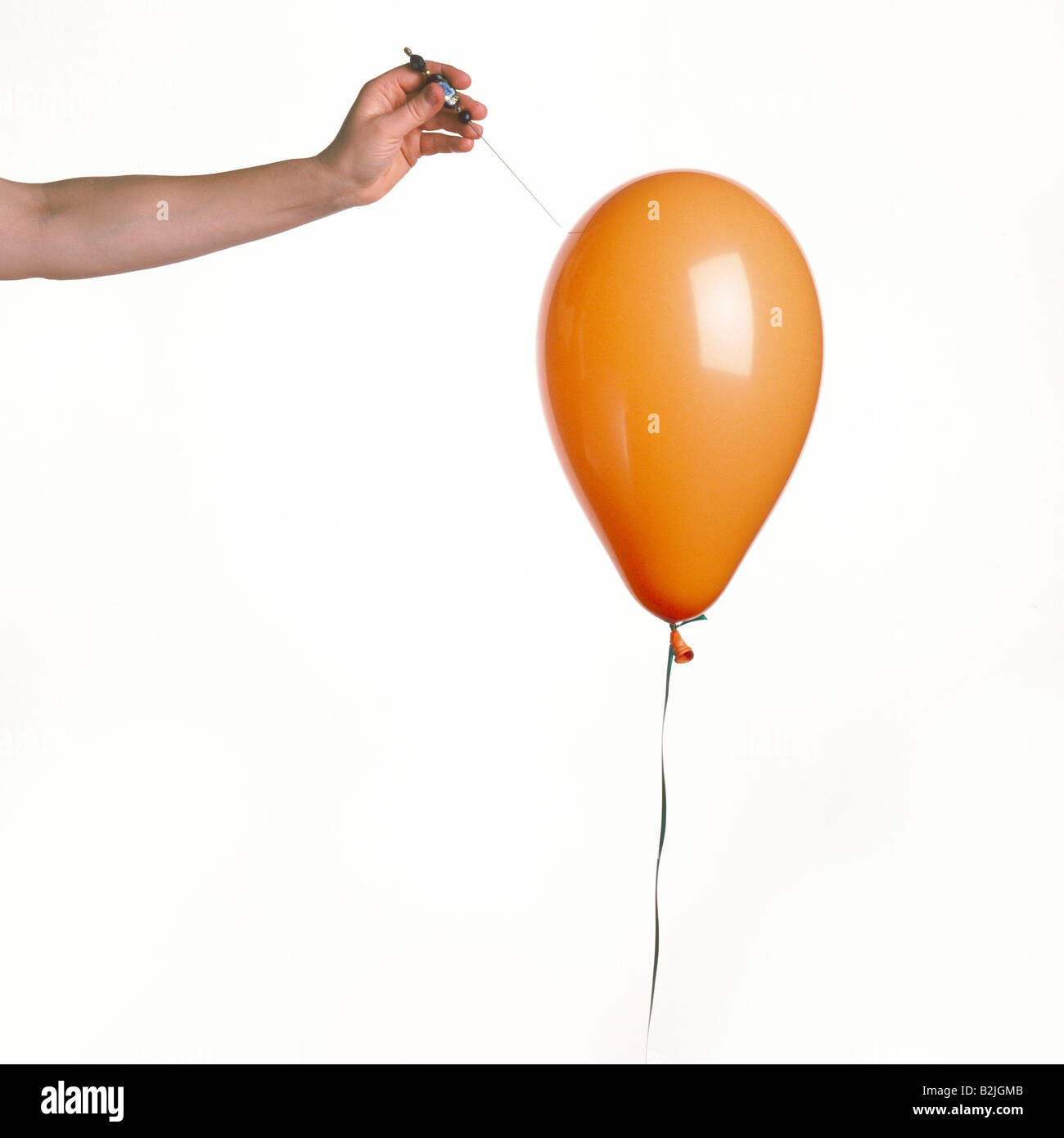 orange balloon with hand cut out on white background Stock Photo - Alamy