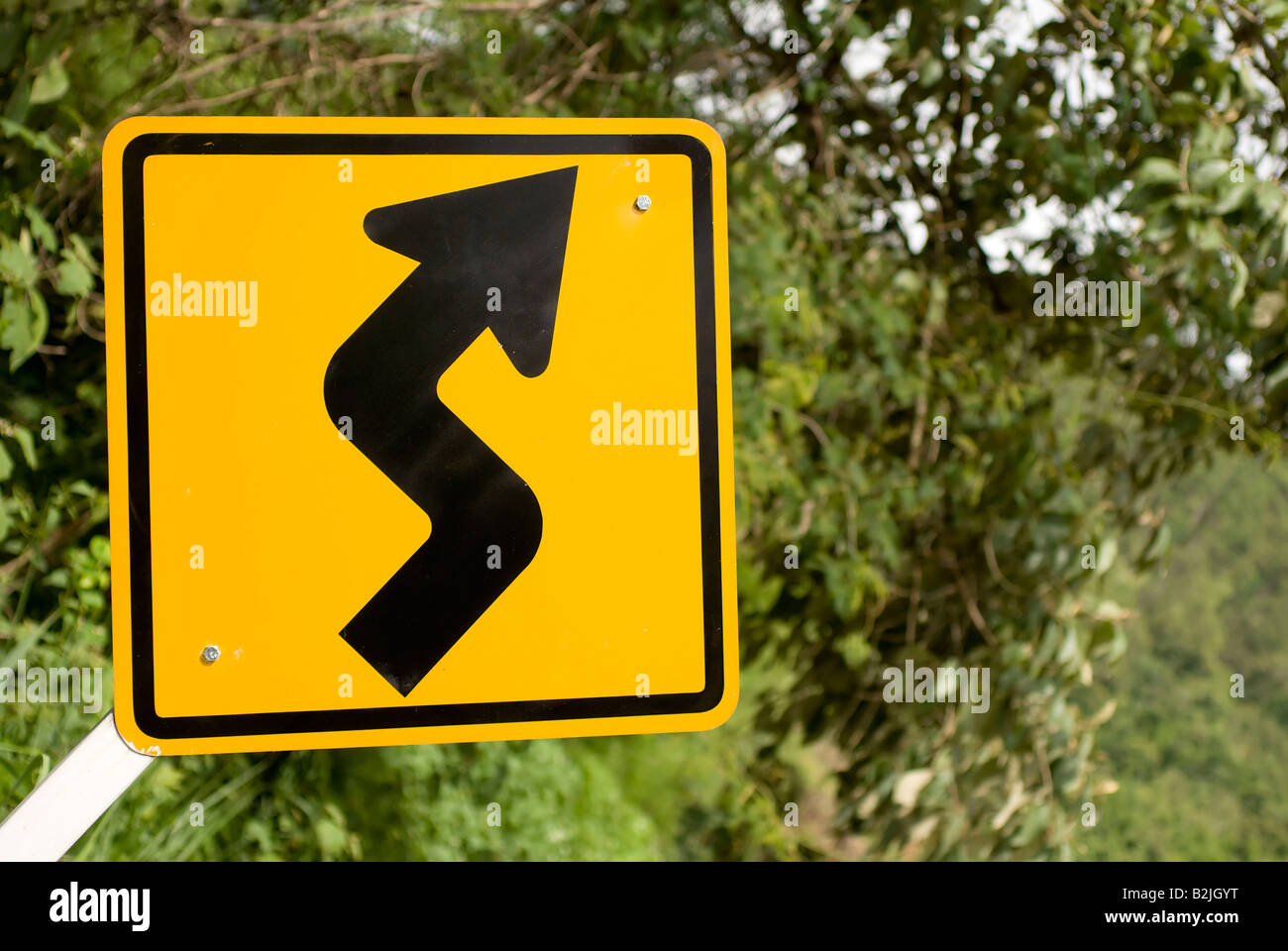 Road sign indicating a windy road ahead Stock Photo - Alamy