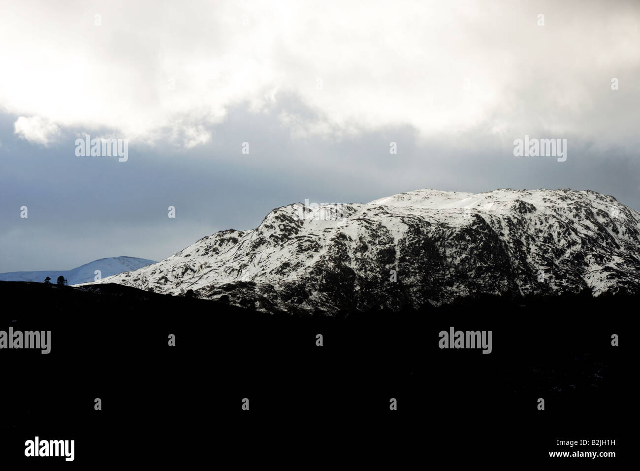 A breif moment of light brightens a brooding, snow laden sky over Glen ...