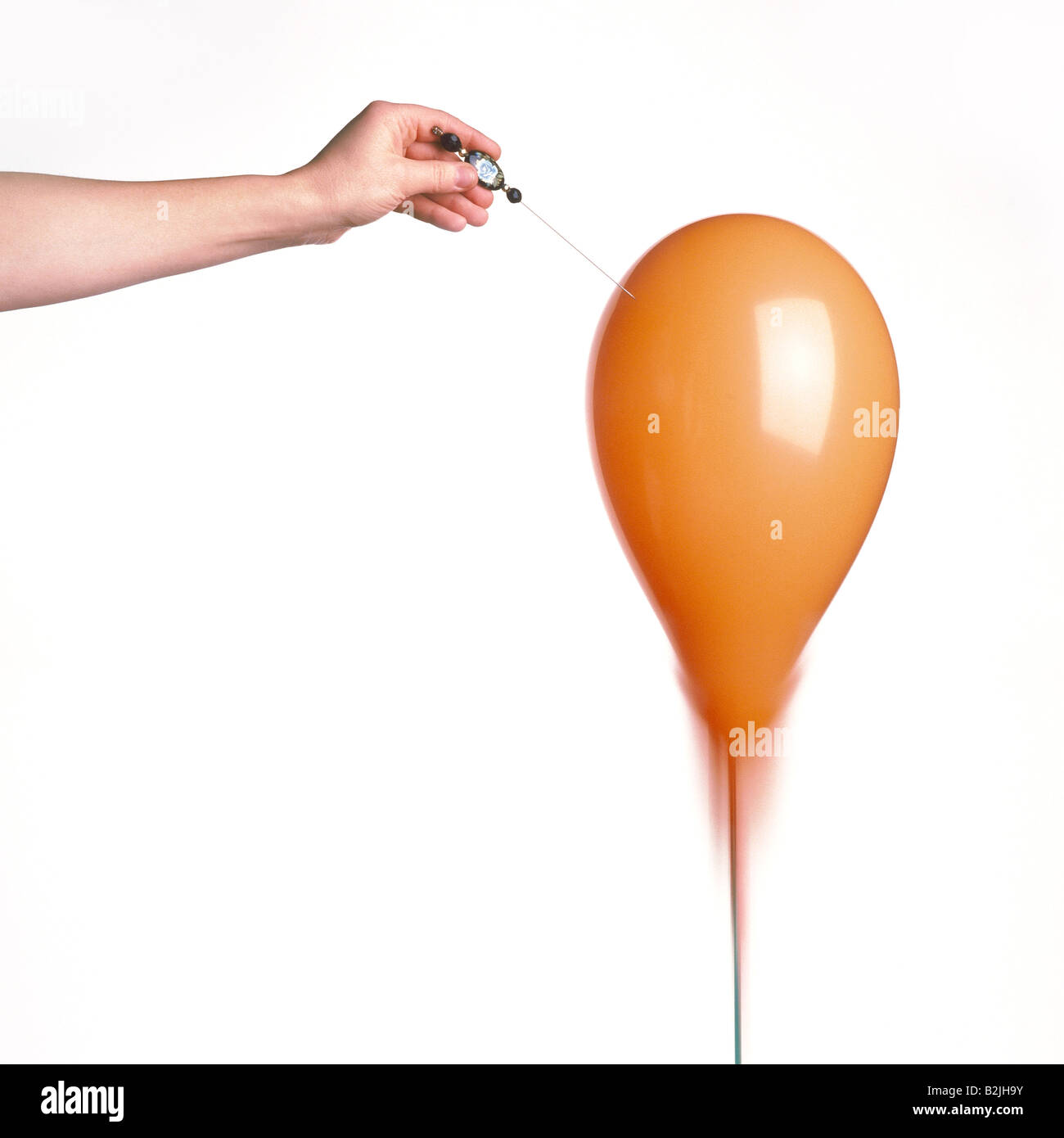 orange balloon with hand cut out on white background Stock Photo - Alamy