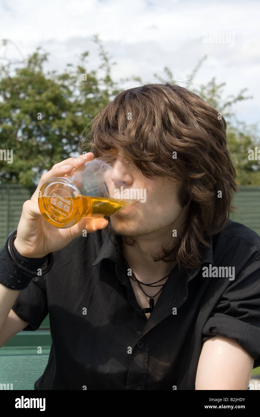 Portrait of teenage boy in a black shirt drinking a pint of cider Stock ...