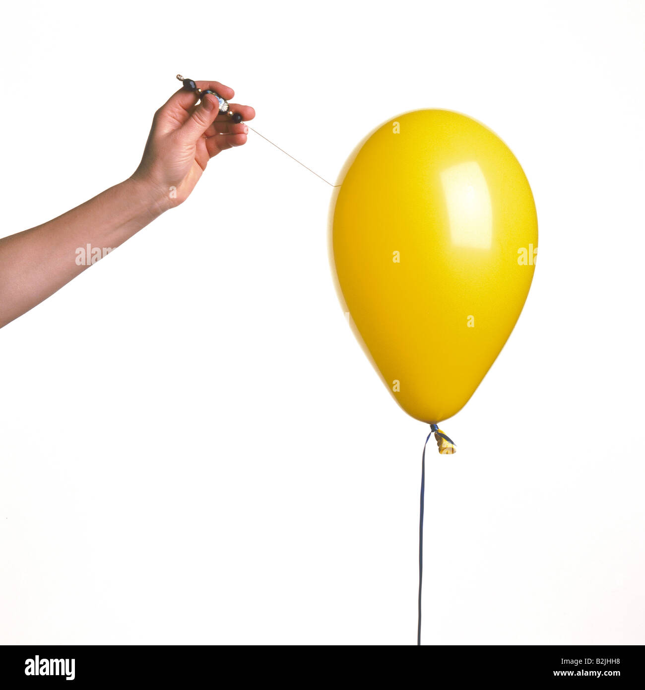 yellow balloon with hand cut out on white background Stock Photo - Alamy