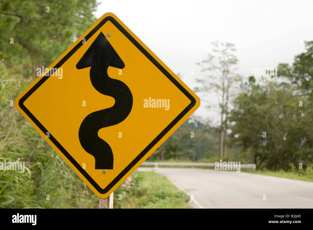 Road sign indicating a windy road ahead Stock Photo - Alamy