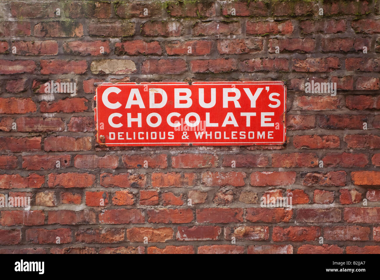 Enamel advertising sign reading 'Cadbury's Chocolate Delicious and ...