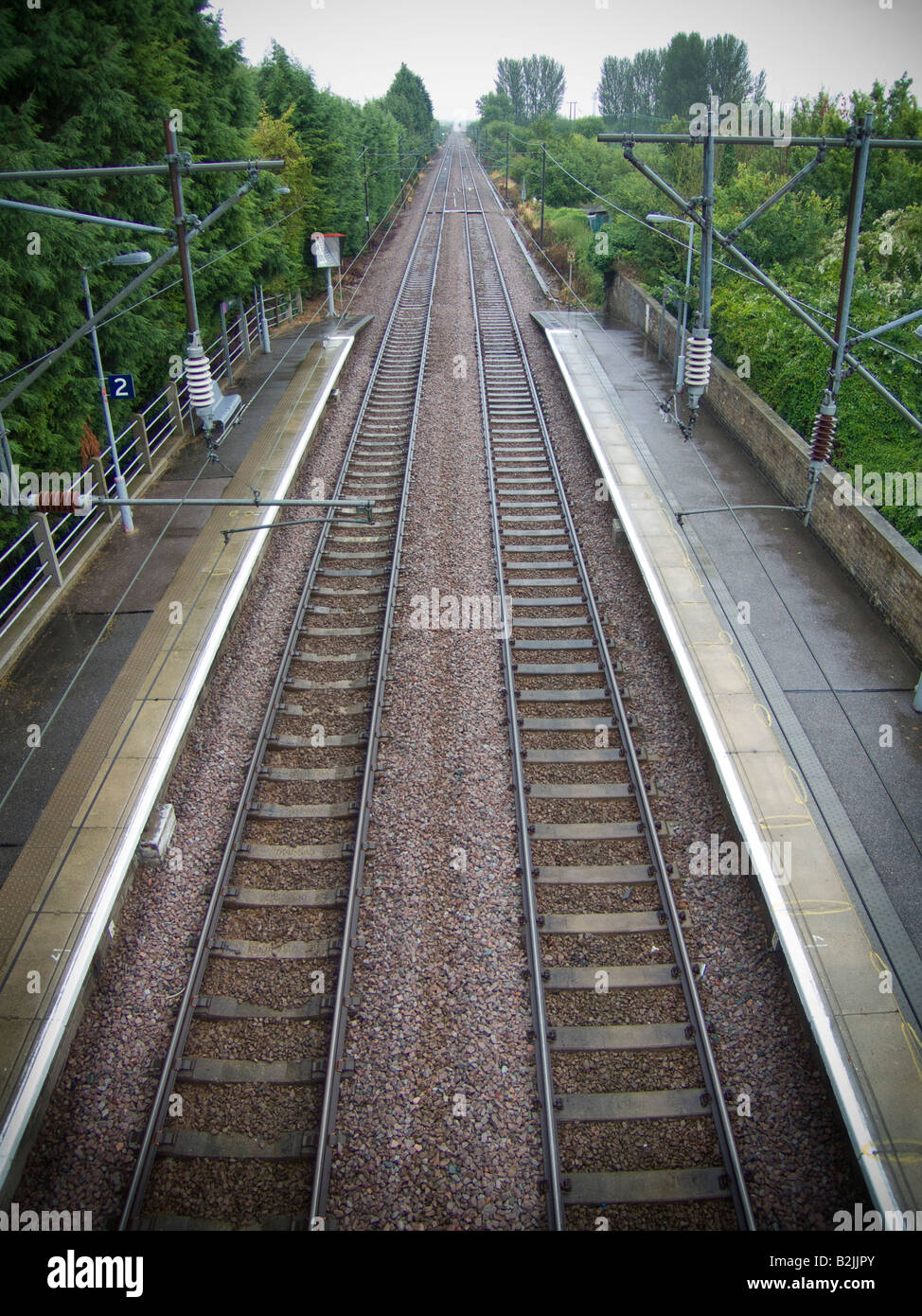 A view down the train track a long staight section of track ...
