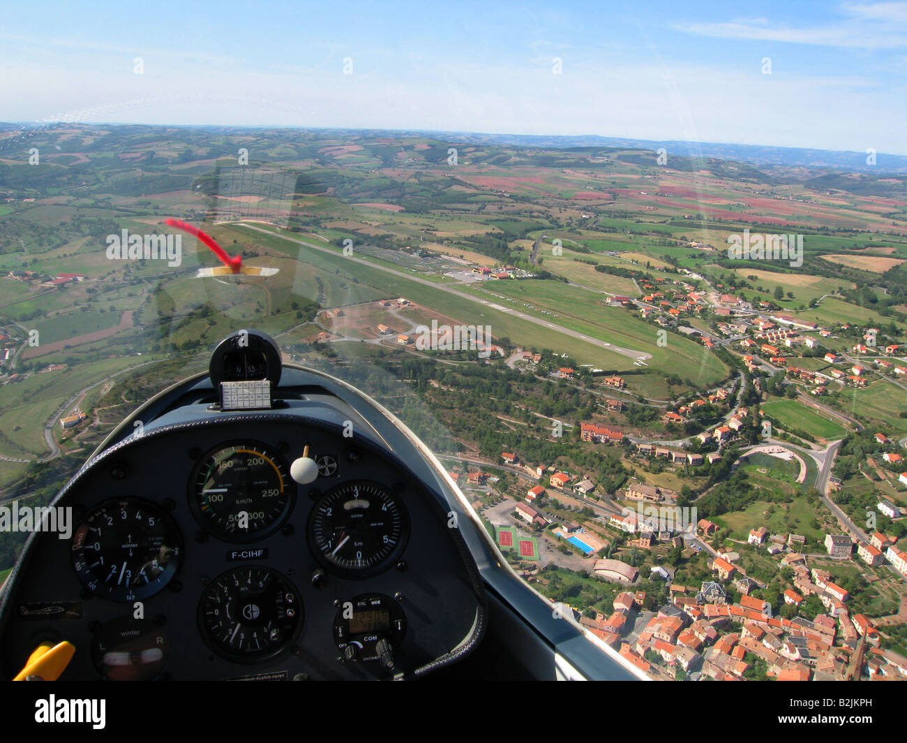 Pilot's eye view from a glider cockpit during flight near the airfield ...