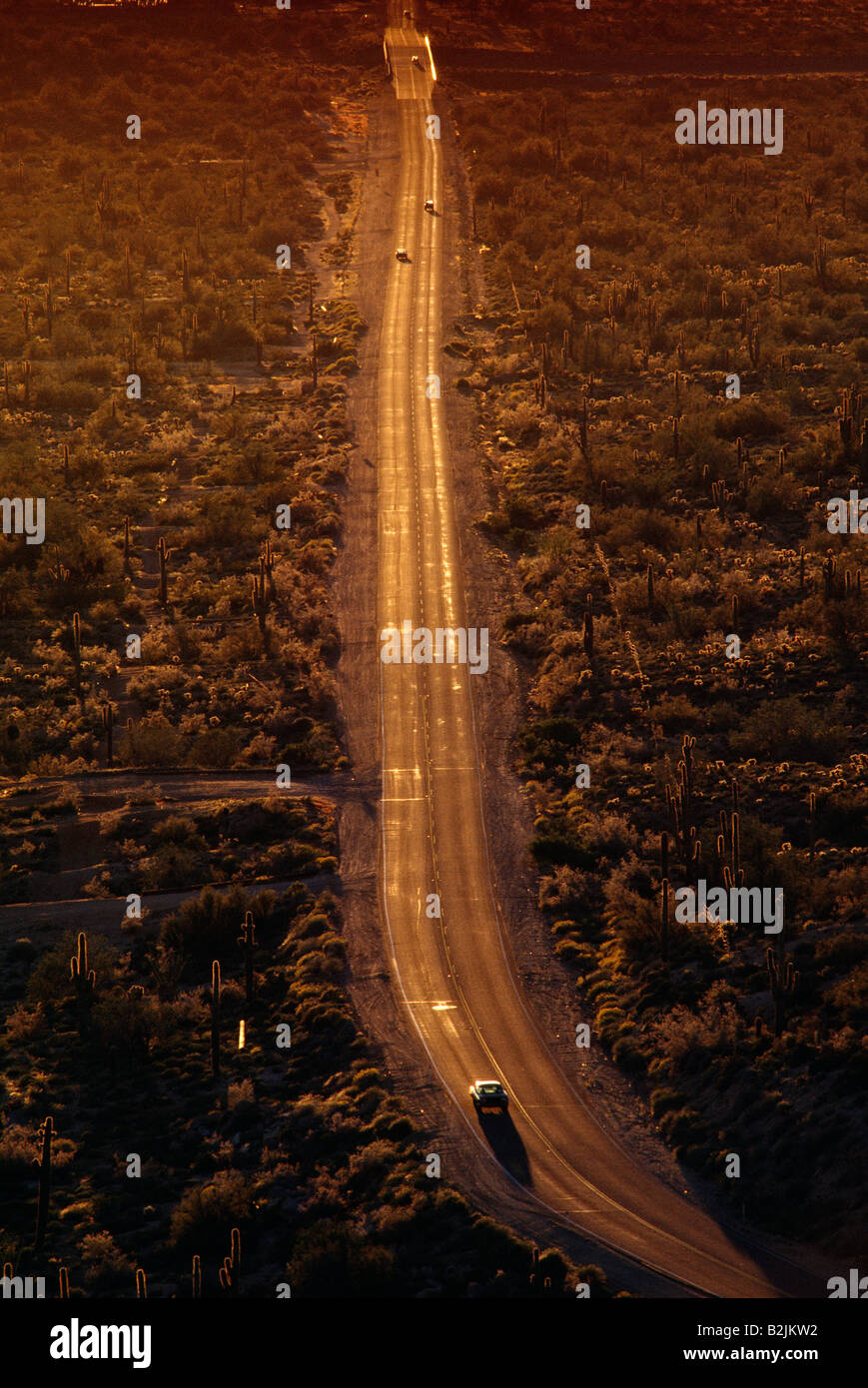 Aerial view of remote country road in the desert of Arizona at sunset ...