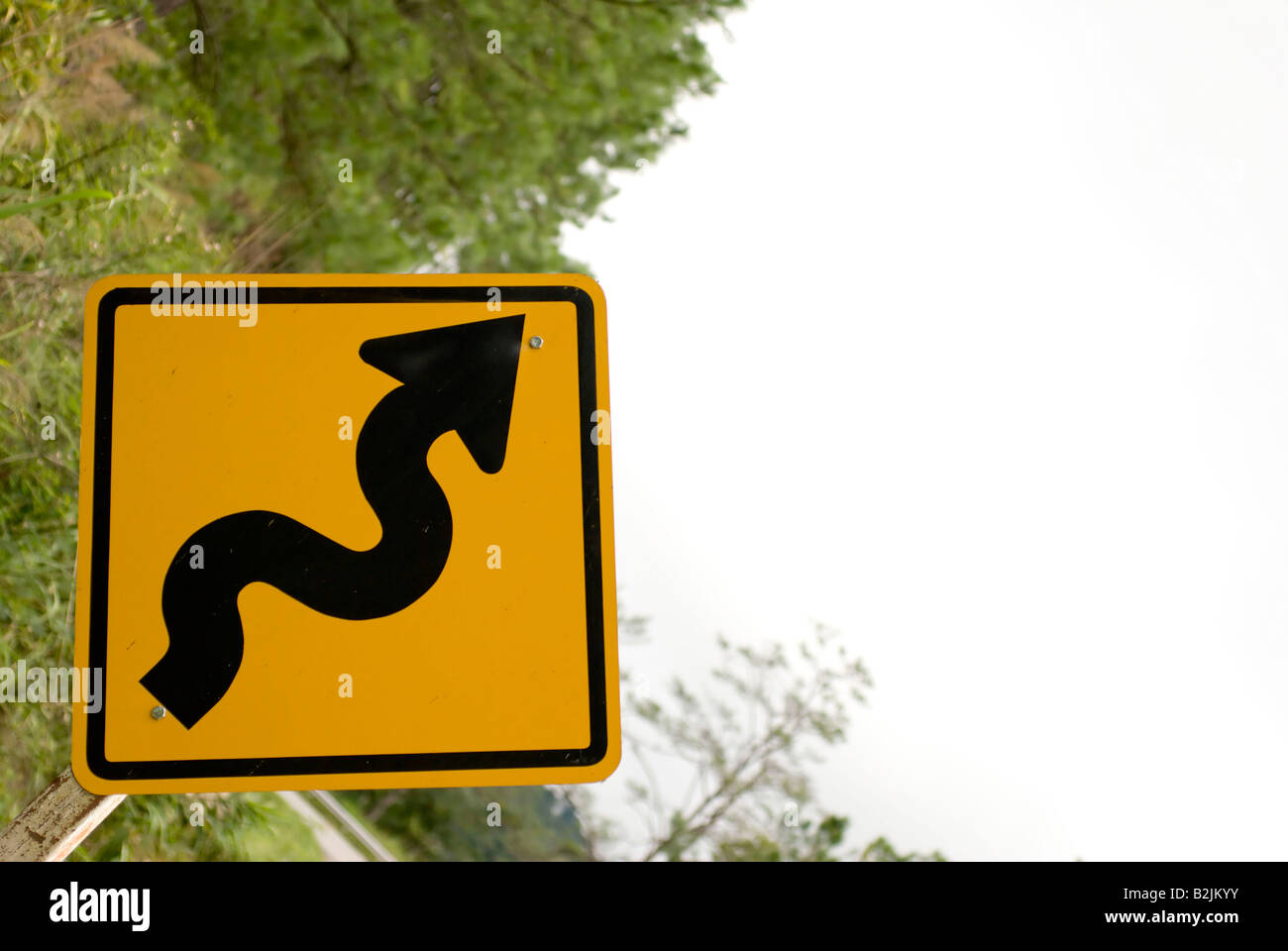 Road sign indicating a windy road ahead Stock Photo - Alamy