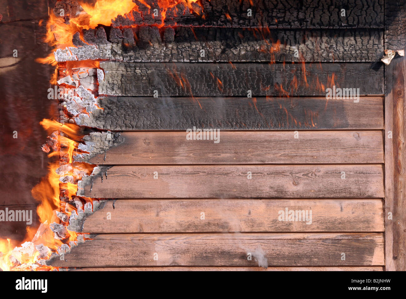 Wood Siding on the house on fire burning off the building Stock Photo ...