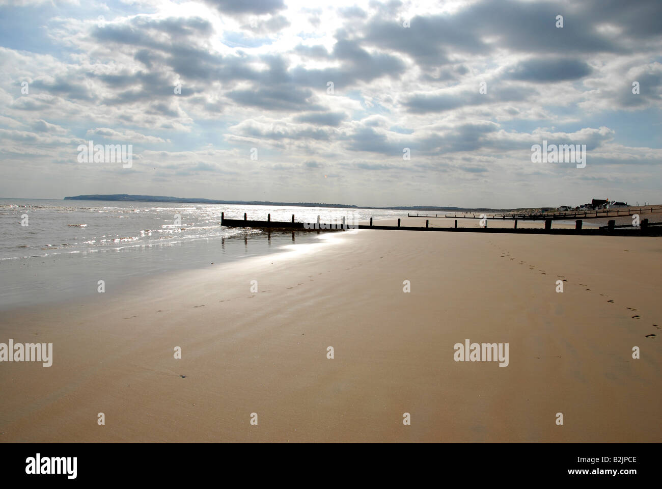 View of wooden groyne sea defence on the beach at low tide, Camber ...