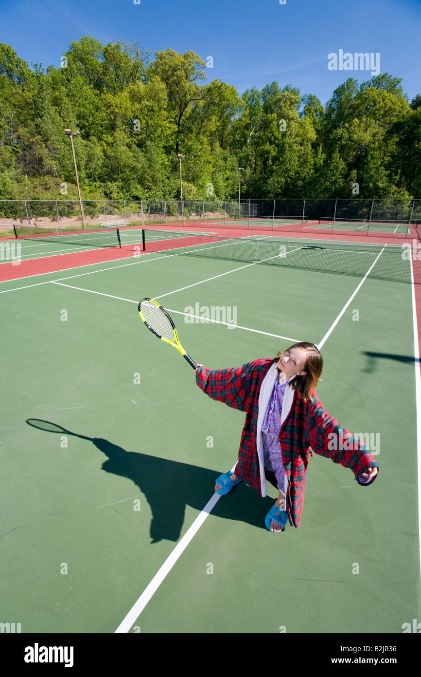 Teenage girl stands on a tennis court with tennis racket Stock Photo ...