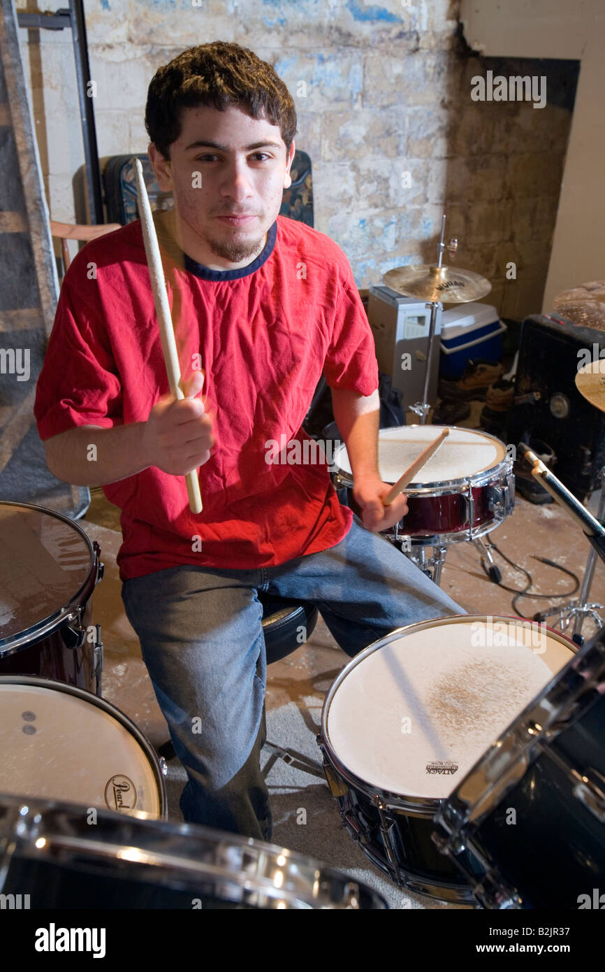 Teenager gets ready to play his drums Stock Photo - Alamy