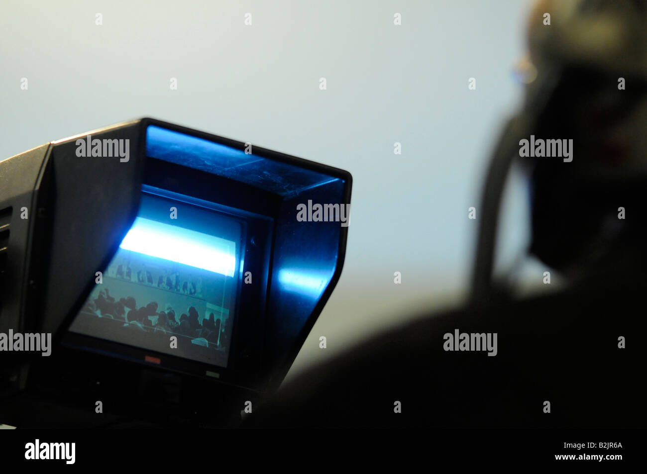 A TV camera operator looking at his screen Stock Photo - Alamy