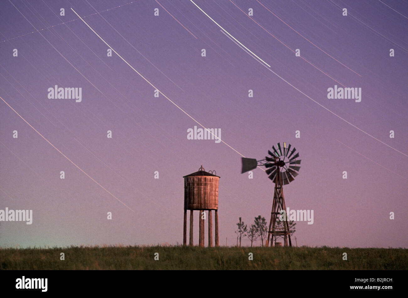 Water Tower and Windmill at night with star shower Stock Photo - Alamy