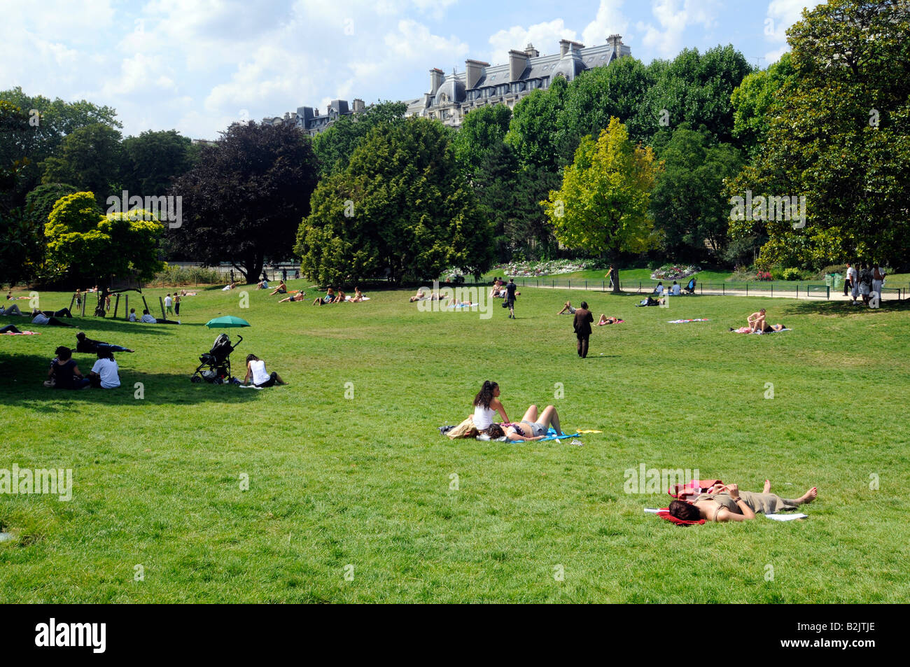 People sunbathing on the lawn in the Parc Monceau in Paris, France ...