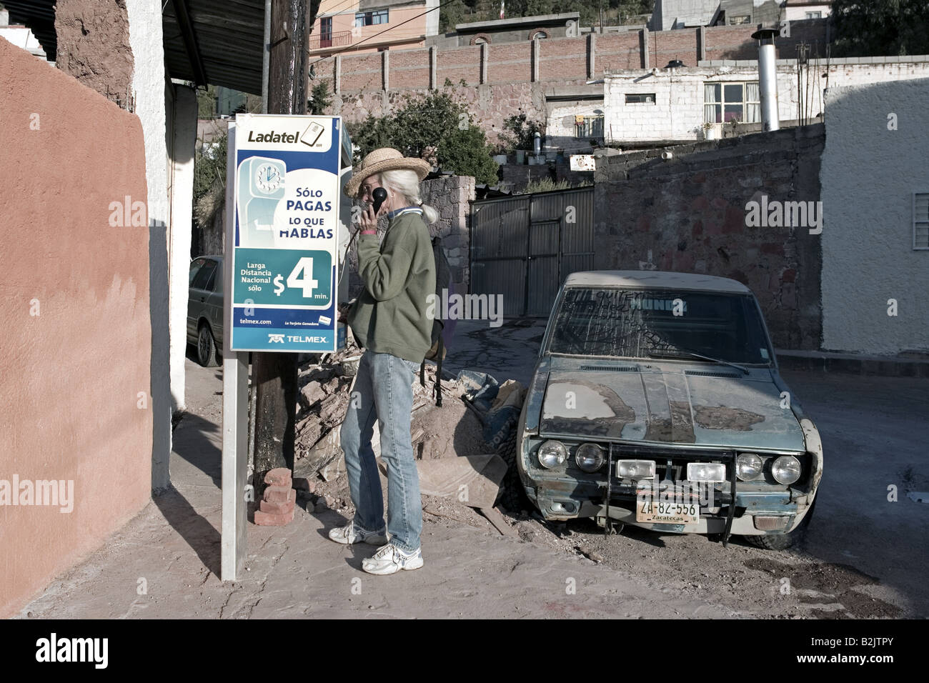 Woman using a public phone in Zacatecas Mexico Stock Photo - Alamy