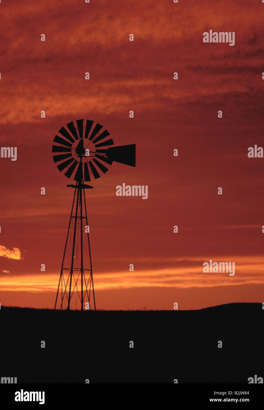 Lonely Windmill at Bright Red Orange Sunset Stock Photo - Alamy