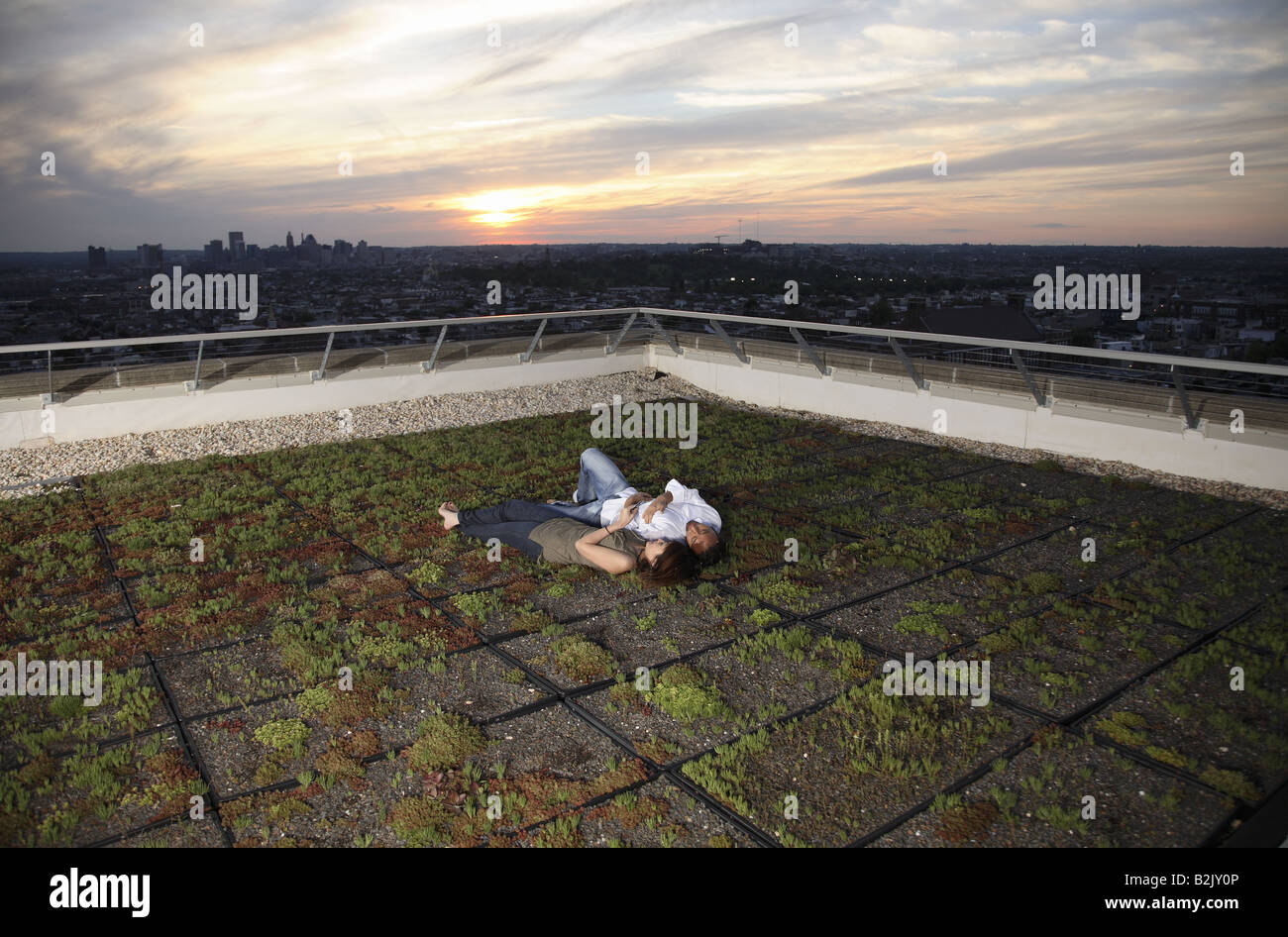 couple relaxing on rooftop Stock Photo - Alamy