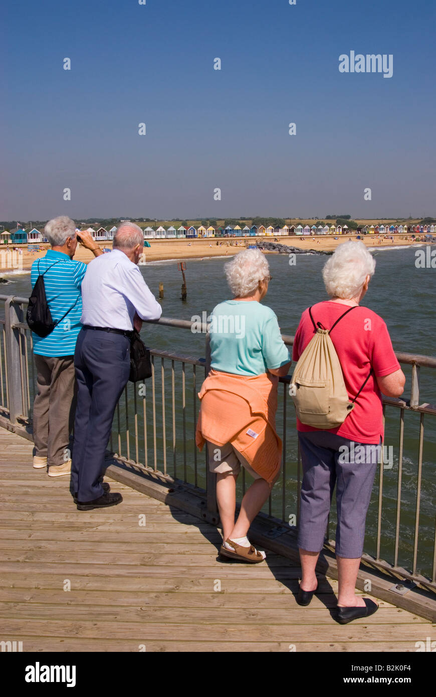 People On Southwold Pier Look Out Over Beach On A Hot Summers Day Stock ...